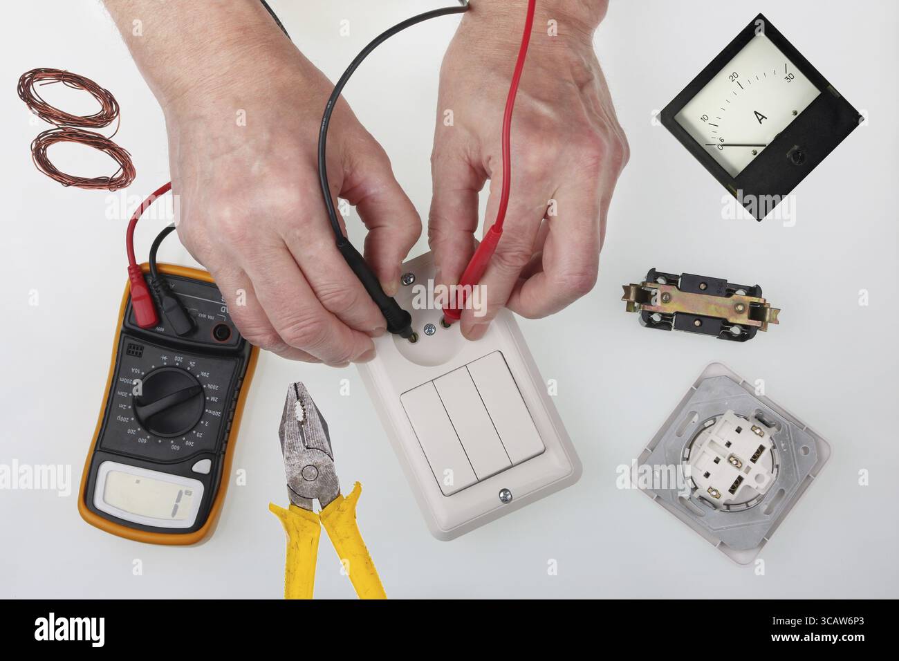 An home master checks the isolation of the light switch using a ...