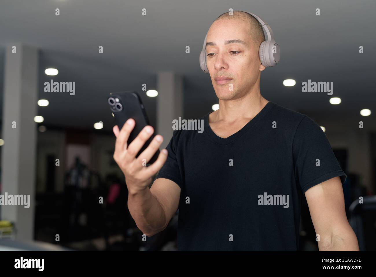 Bald man checking smartphone happy hi-res stock photography and images ...