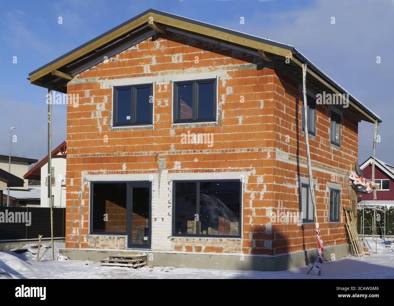 Construction of the mass production no name red brick house, incomplete ...