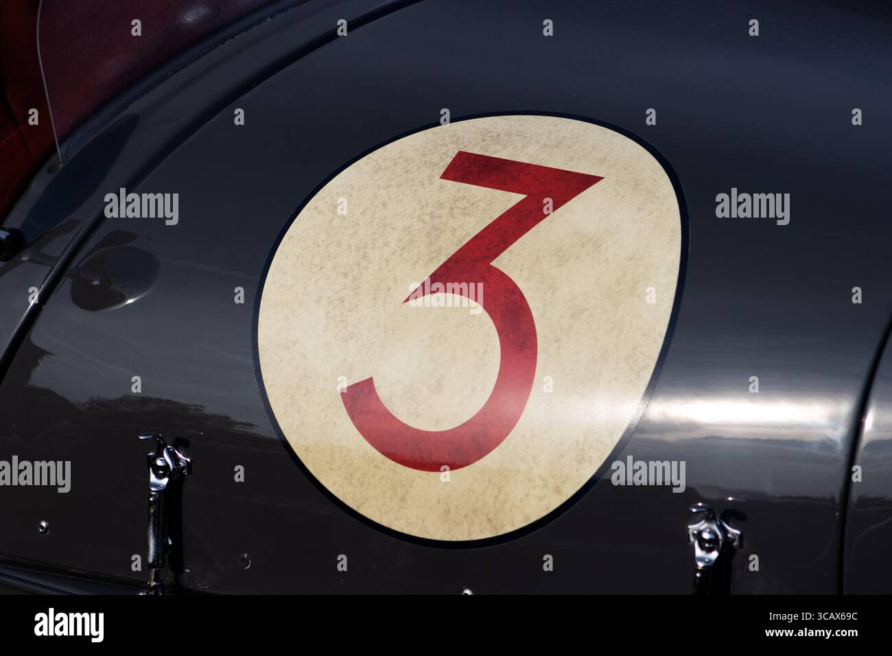 red number 3 in a white circle on the front to an old fashioned racing ...