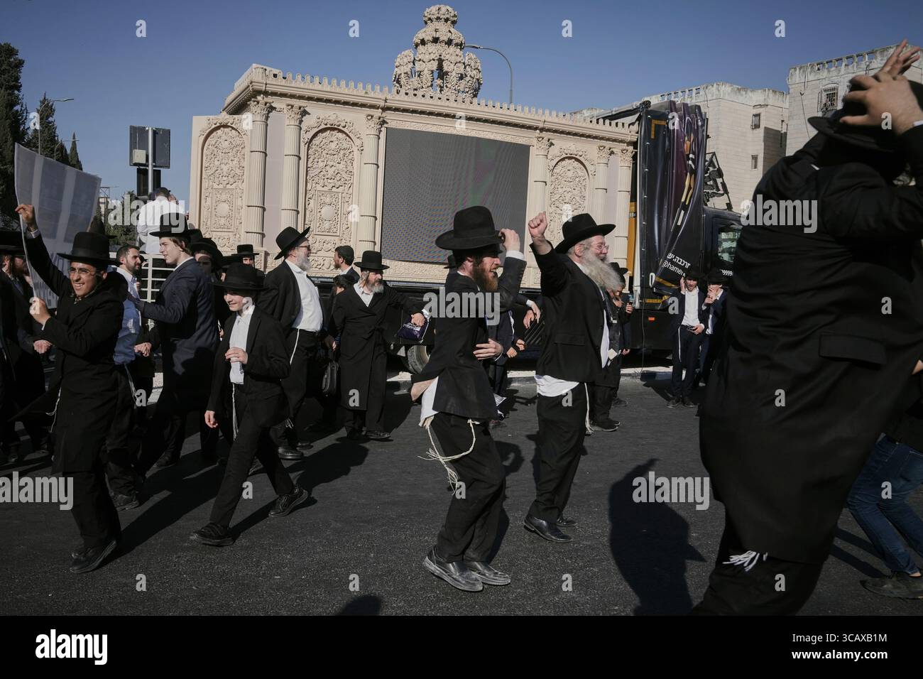 Ultra-Orthodox Jewish men block a road during a protest against army ...