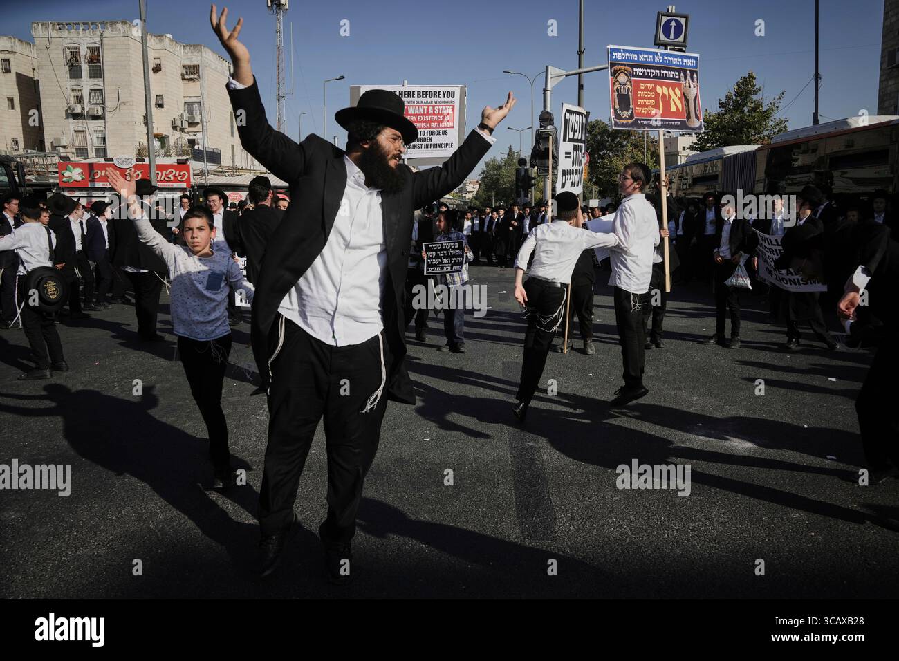 Ultra-Orthodox Jewish men block a road during a protest against army ...