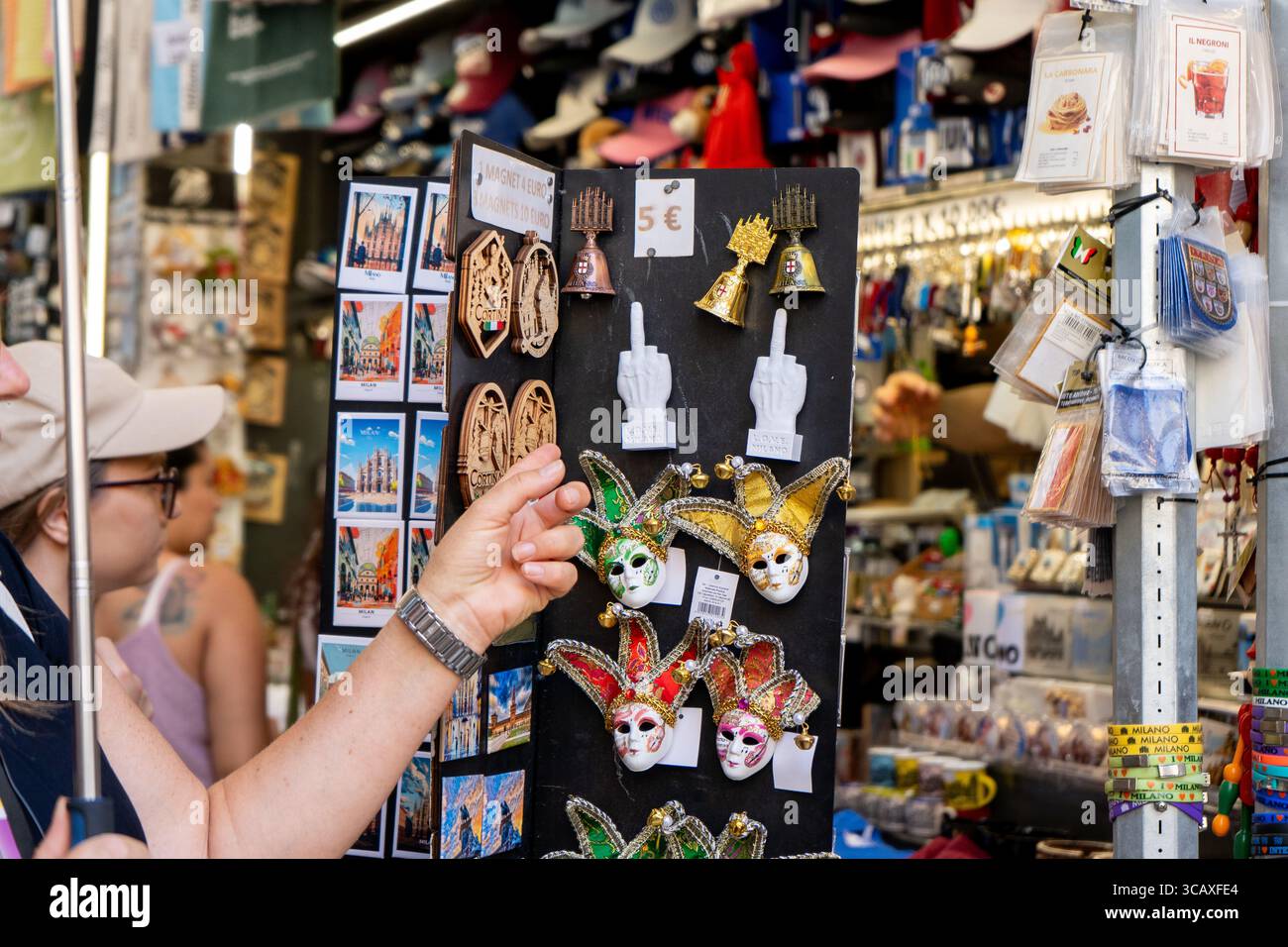 Souvenir magnets from Italy are sold on the street. Middle finger ...