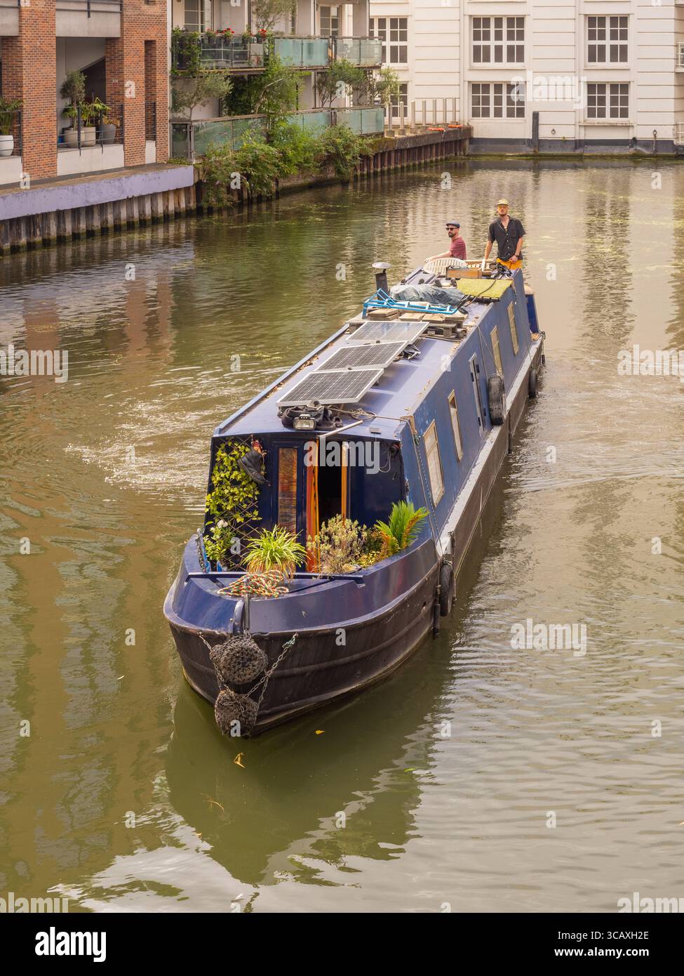 Two people on a traditional narrowboat, a common sight on the Regent's ...