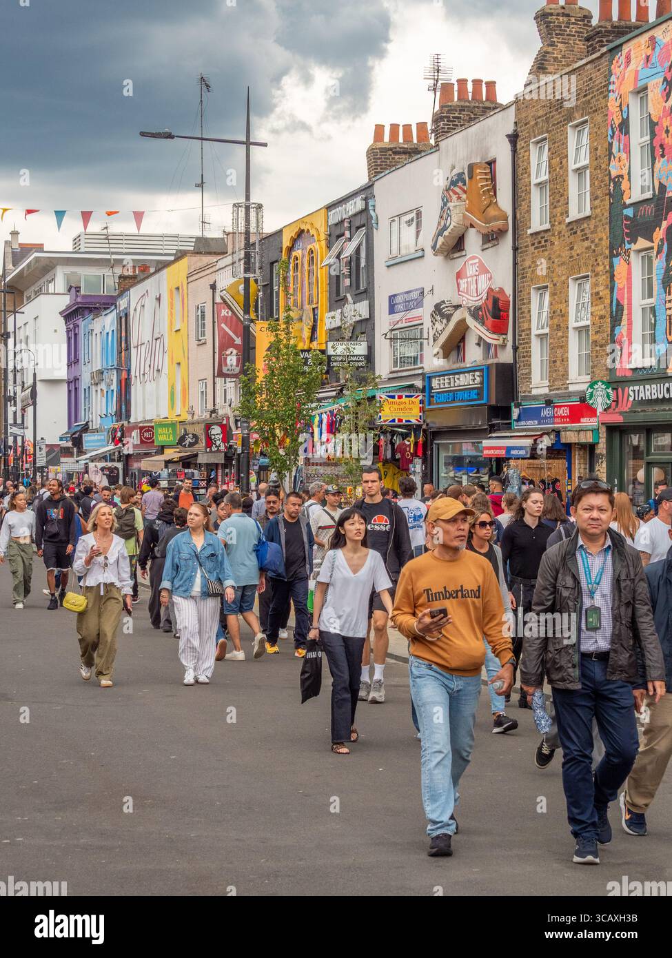 A diverse crowd of people exploring the unique shops, including a ...