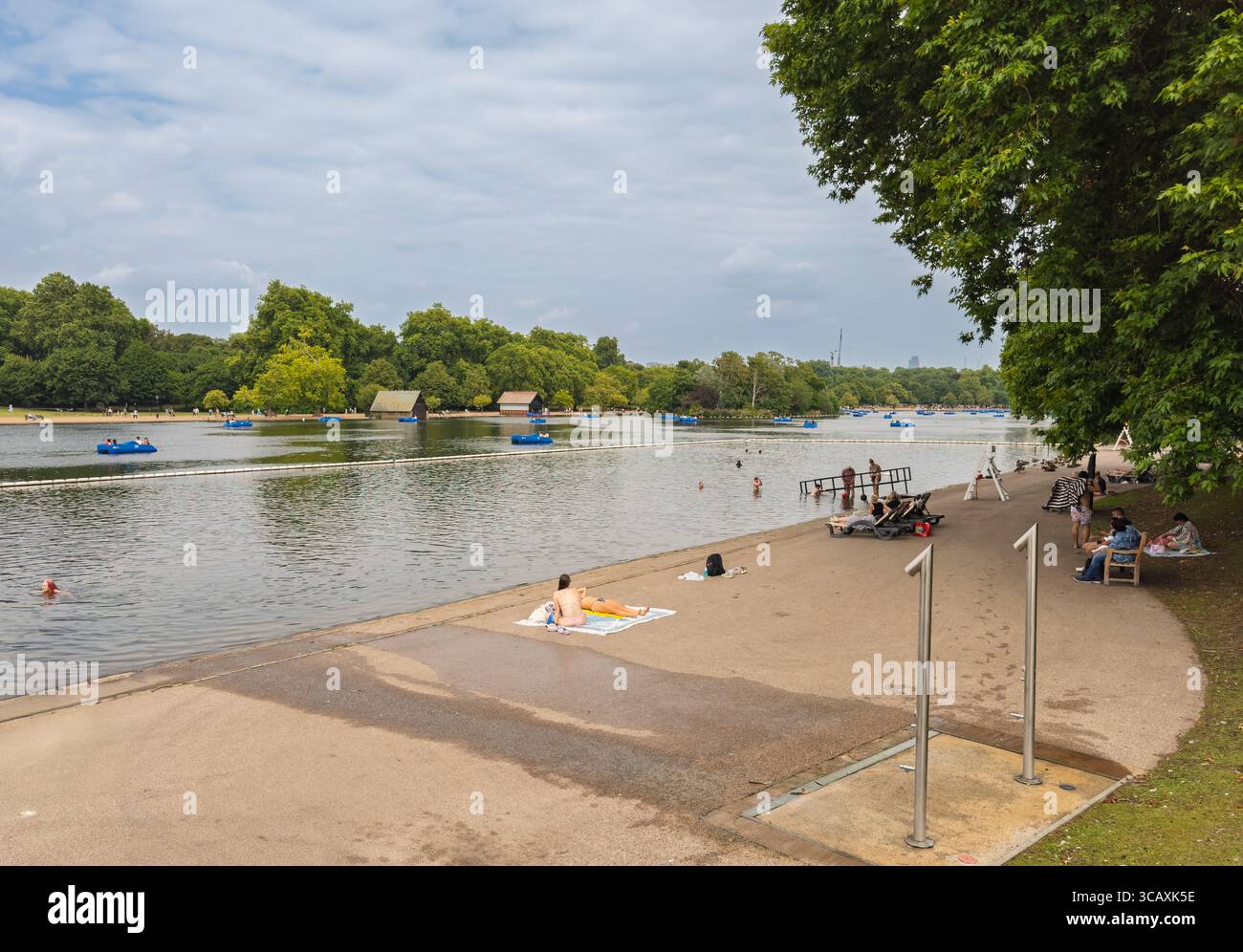 People swimming and sunbathing at the Serpentine Lido in Hyde Park on a ...