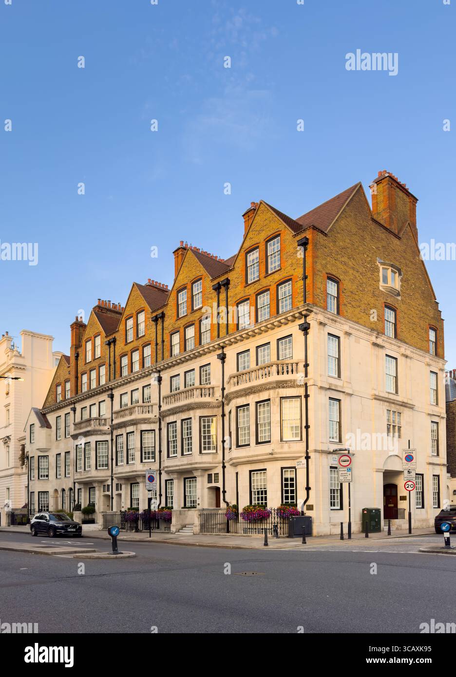 A grand corner townhouse with Queen Anne style gables, typical of the ...