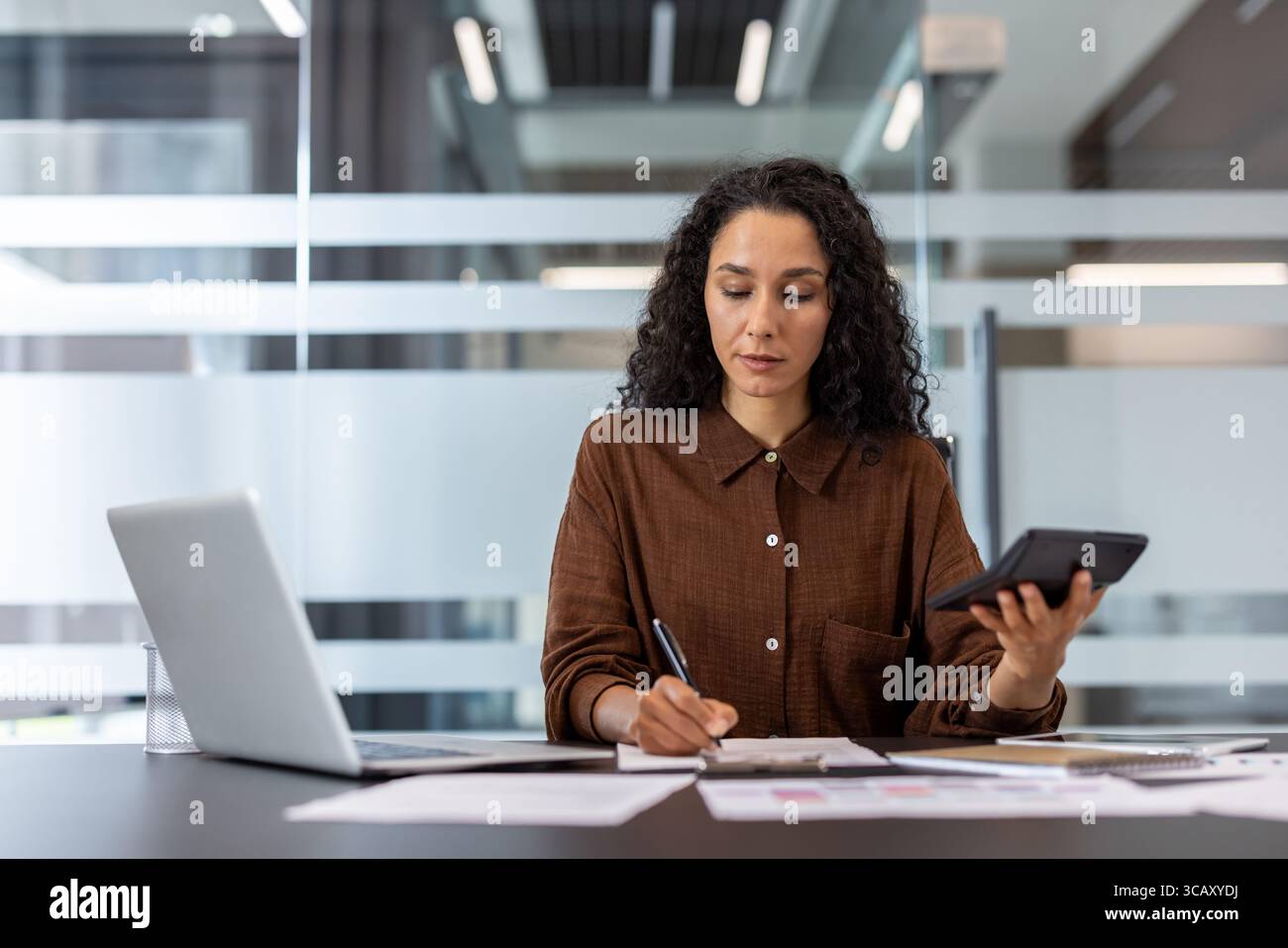 Diligent indian female professional sitting hi-res stock photography ...