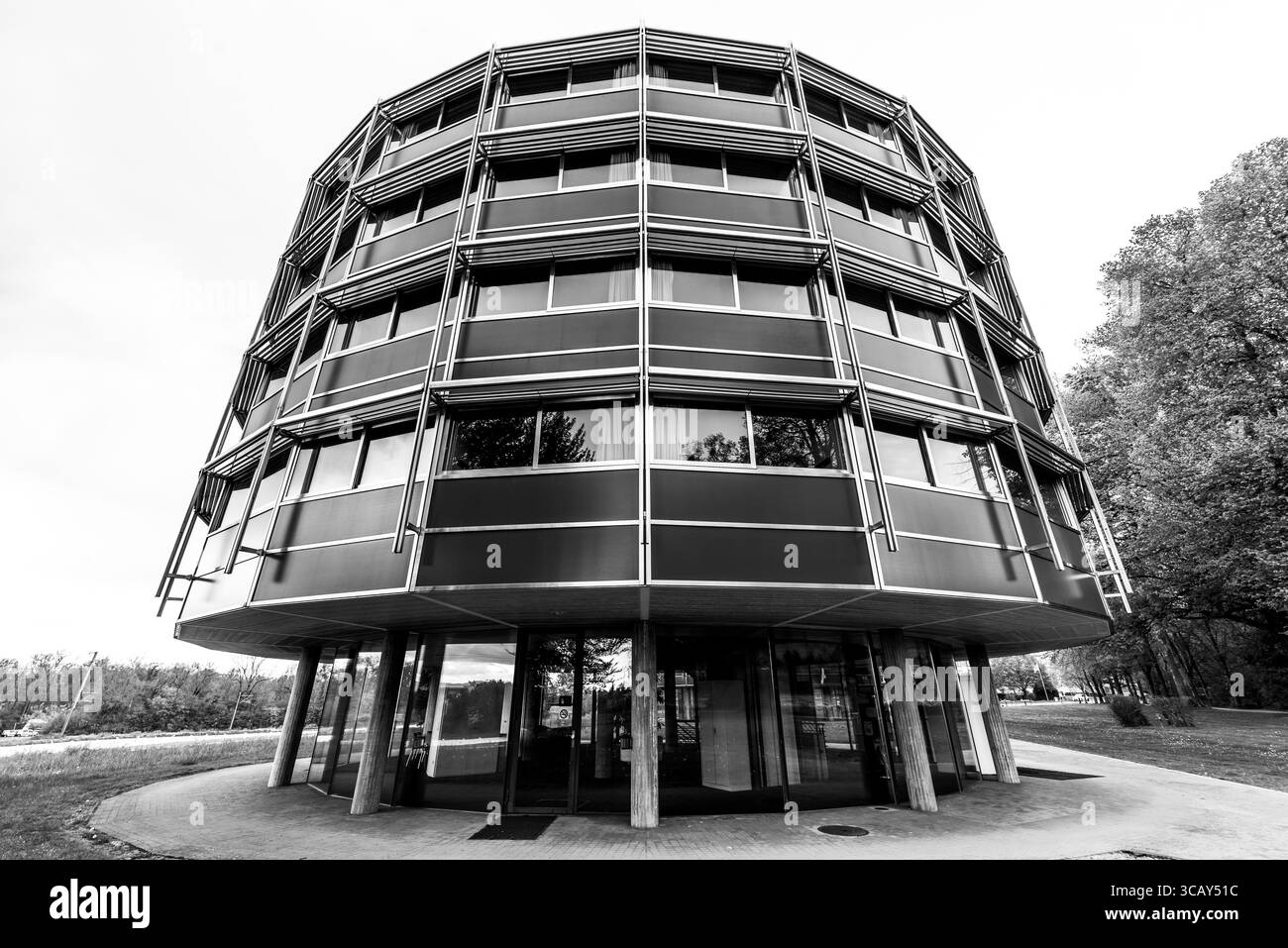 Modern round office building with glass facade and metal structure in ...