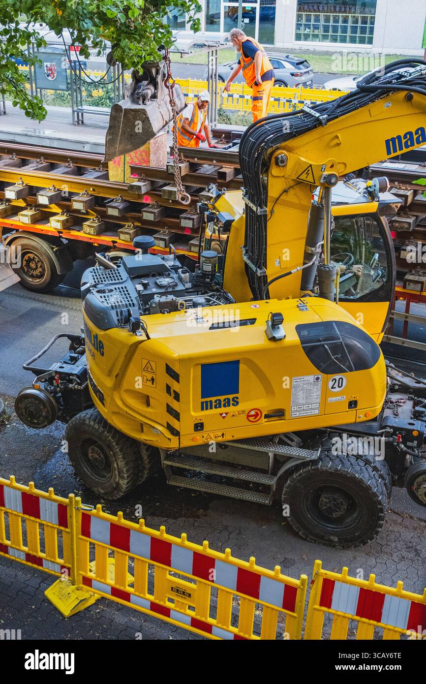 Construction workers and excavators at a tram rail worksite Stock Photo ...