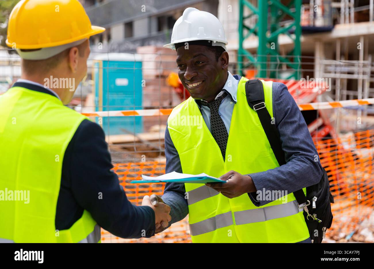 Architect and engineer construction workers shaking hands while working ...