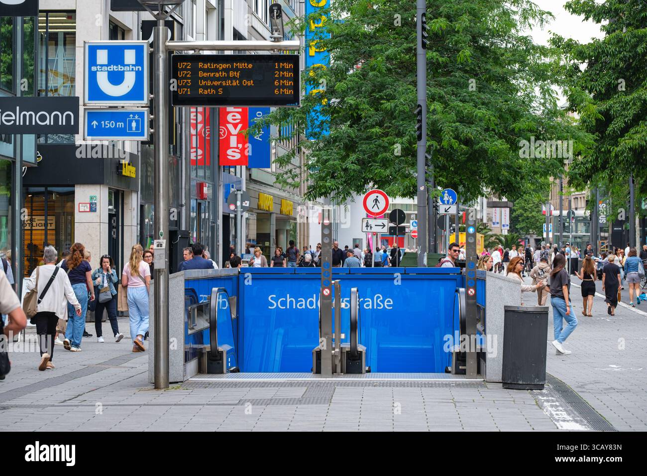 Urban subway entrance surrounded by people on a busy street Stock Photo ...