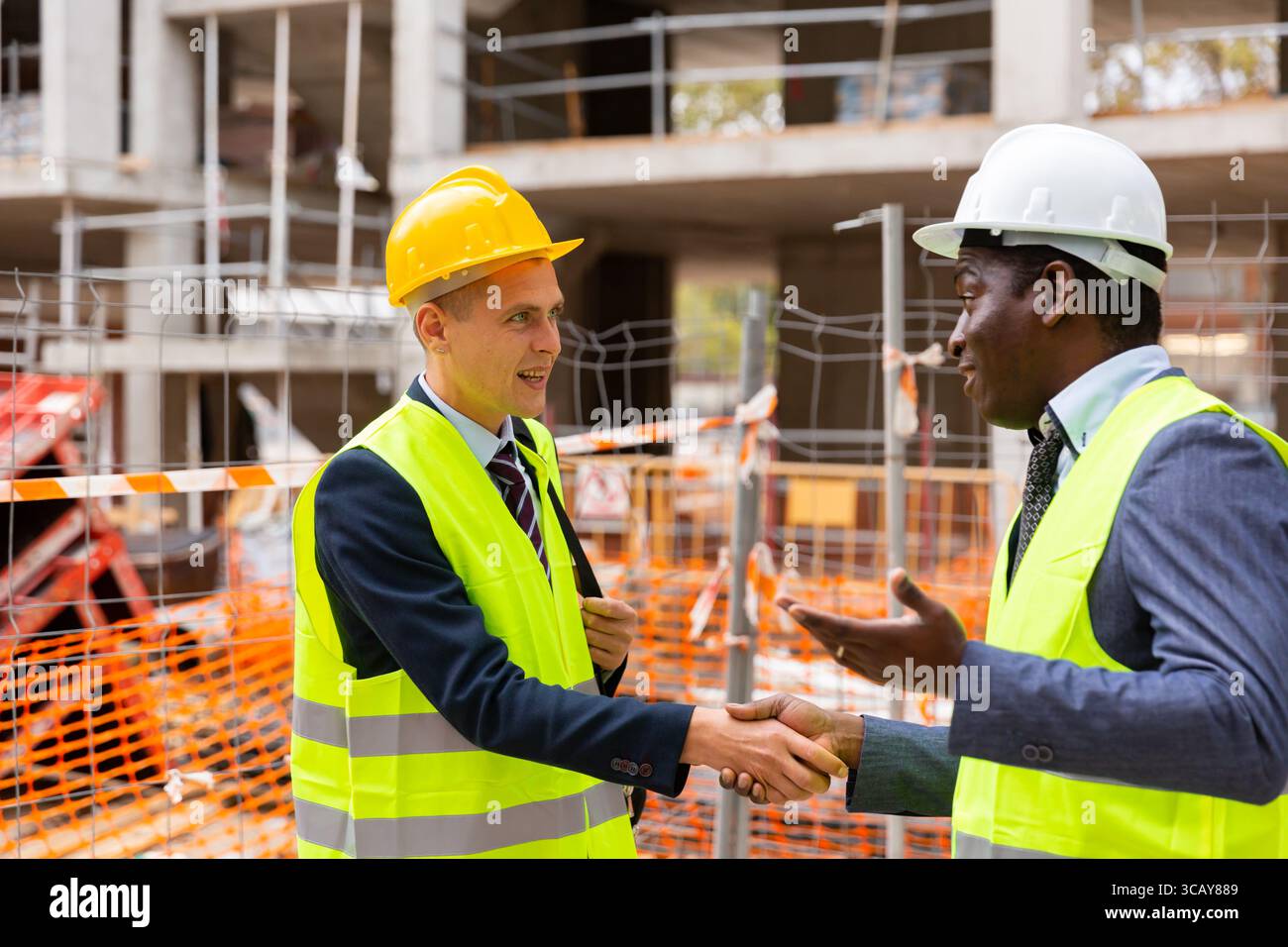 Two successful civil engineers exchange a friendly handshake Stock ...