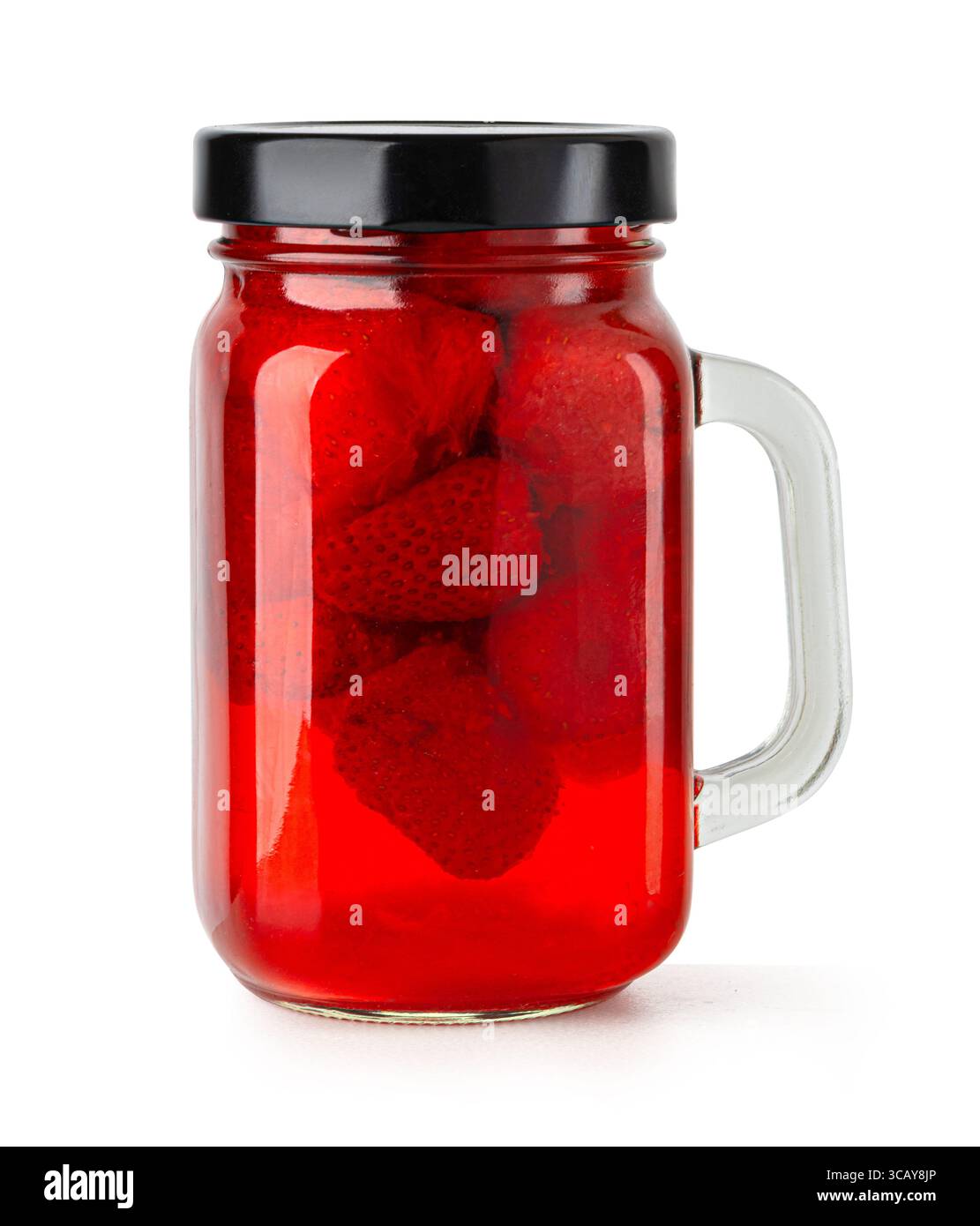 Ripe red strawberries preserved in syrup, inside a glass jar with ...