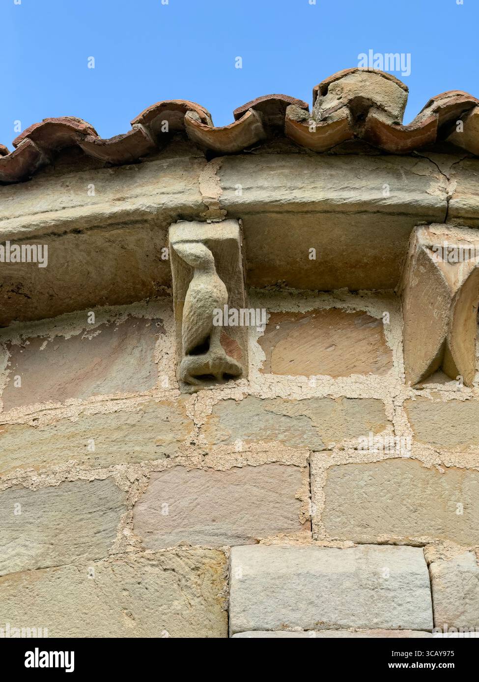 Detail of sculpted corbels with faces and spiral motif on Romanesque ...