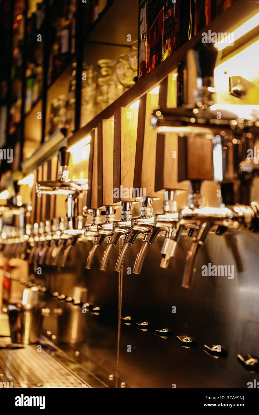 Beer taps at pub bar counter Stock Photo - Alamy