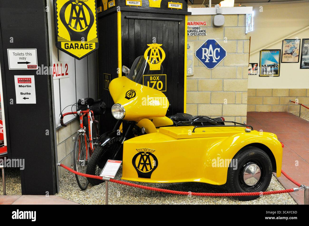 A BSA motor cycle and sidecar combination in front of an AA telephone ...