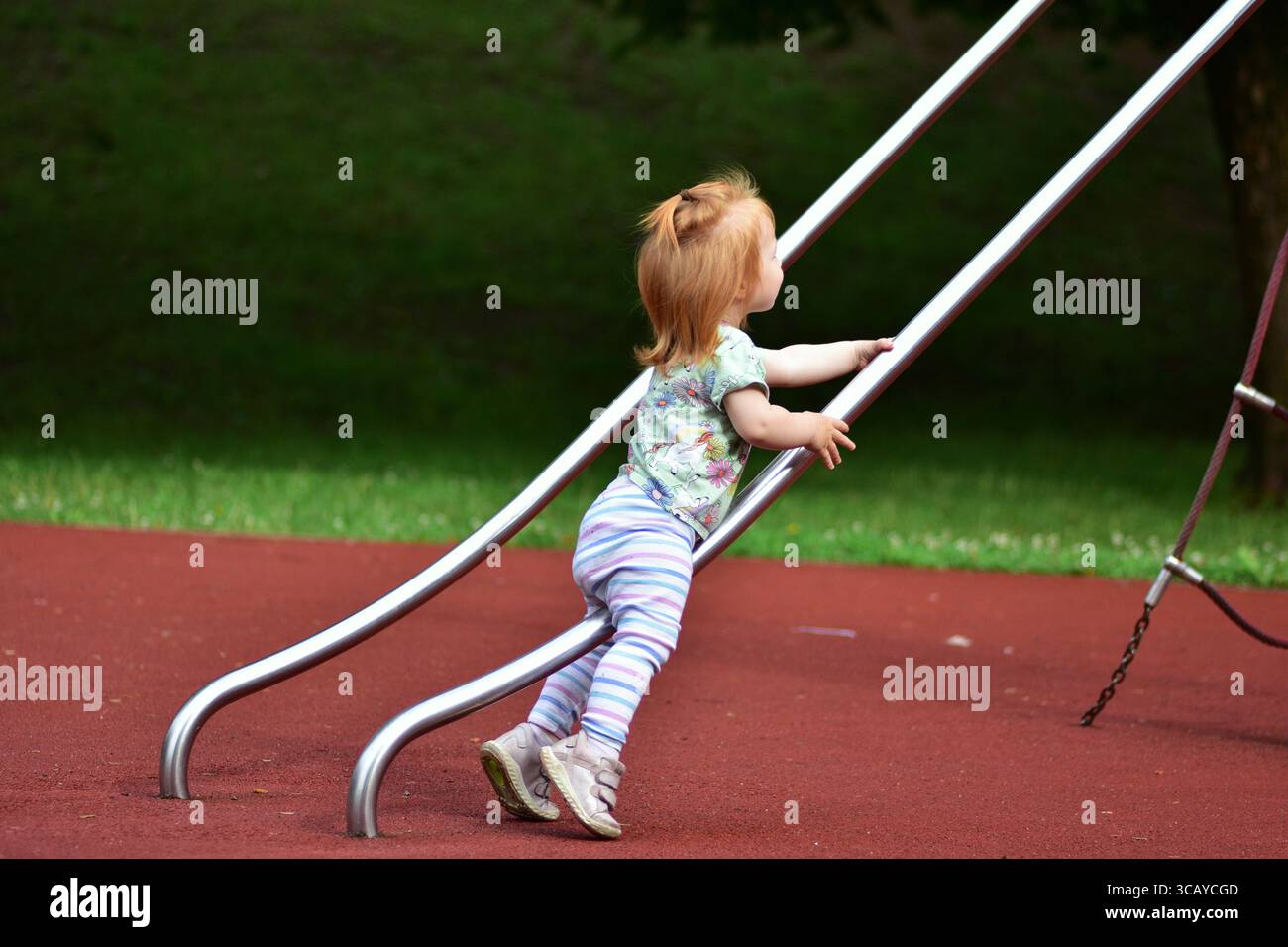 Girl climbing up slide hi-res stock photography and images - Alamy