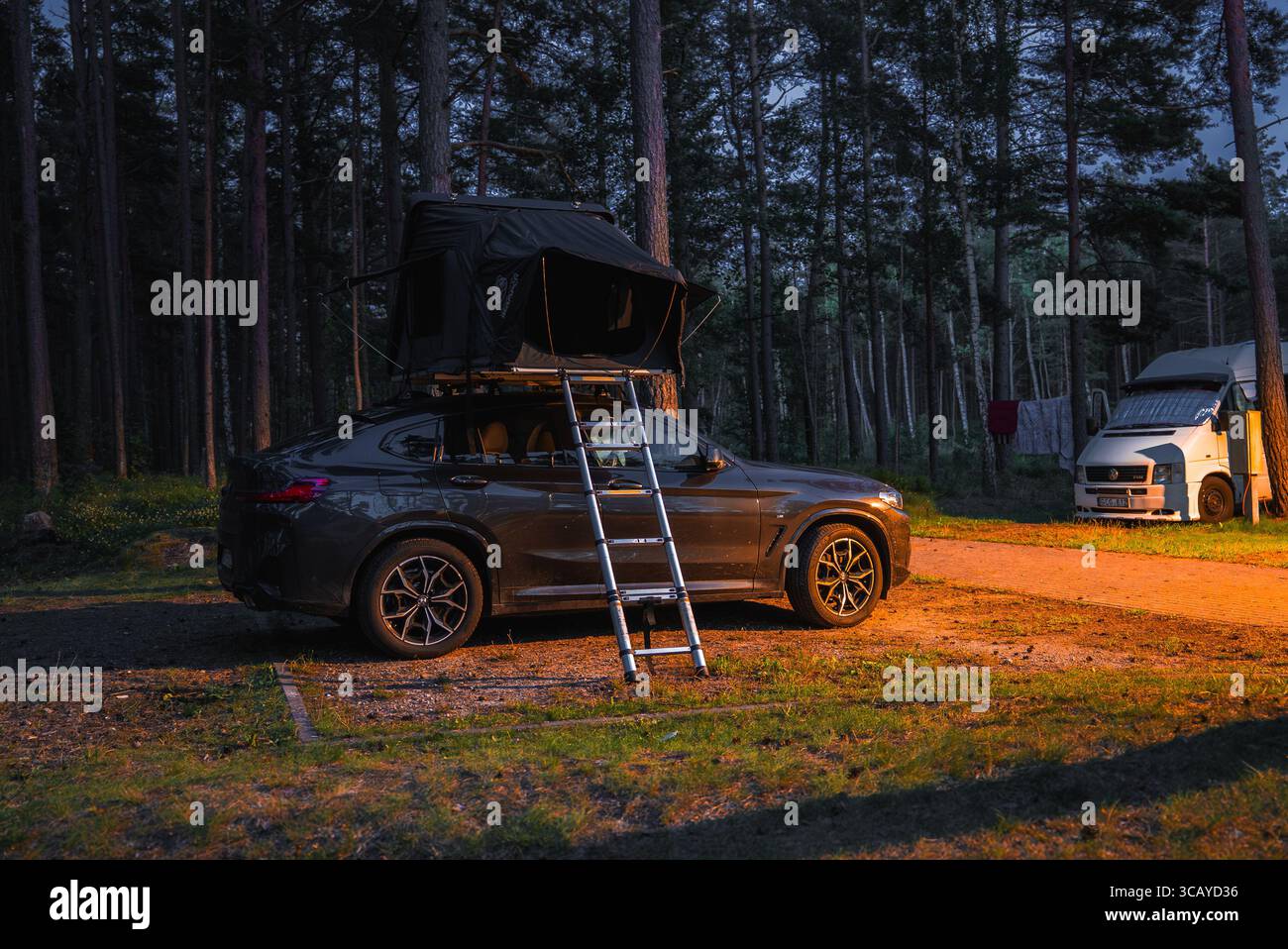BMW X4 2025 with Rooftop Tent in a Forested Camping Area Stock Photo ...