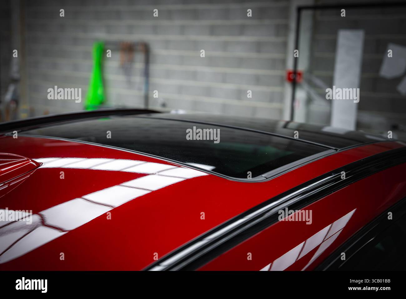 Red Luxury Car Sunroof and Roofline in a Garage Setting Stock Photo - Alamy
