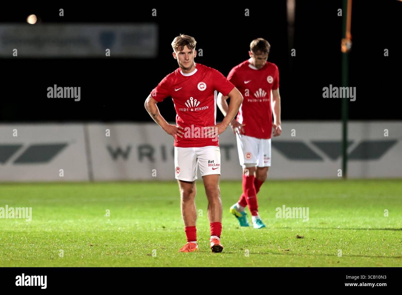 Larne's Dylan Sloan (left) and team-mate appear dejected following ...