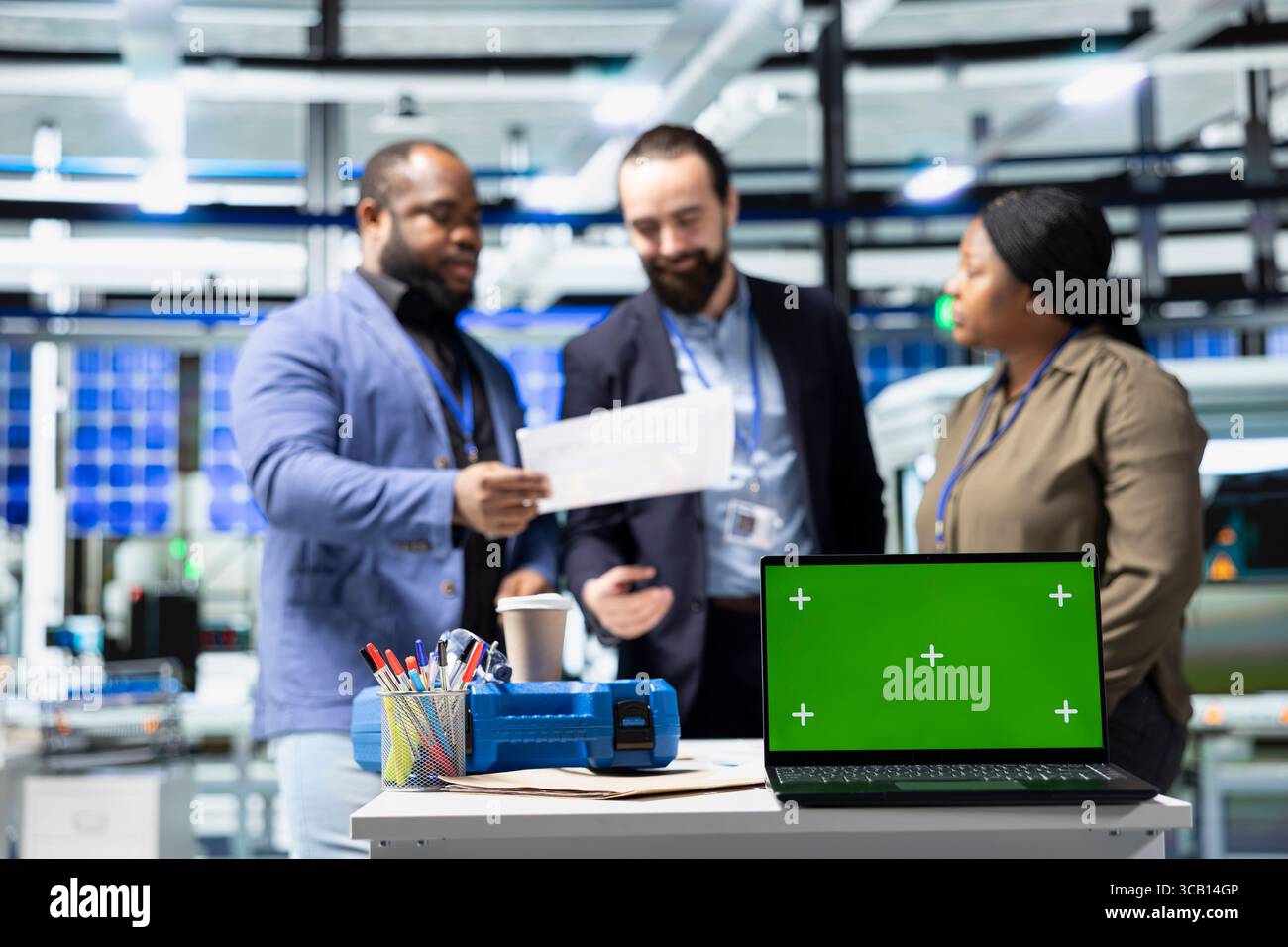 Professionals engineering group reviews solar panels next to chroma key ...