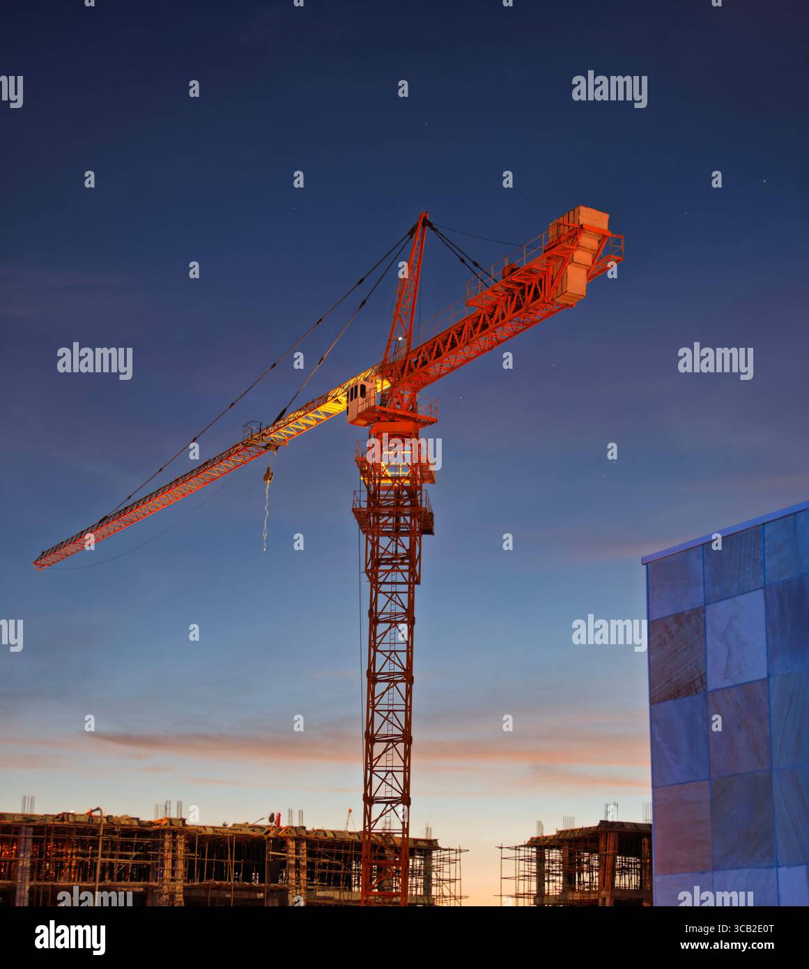 top-slewing crane, tower crane at construction site , against the night ...