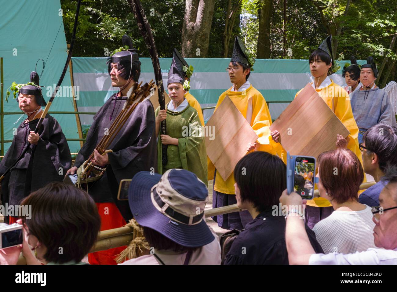 A traditional Japanese ceremony featuring participants in formal attire ...