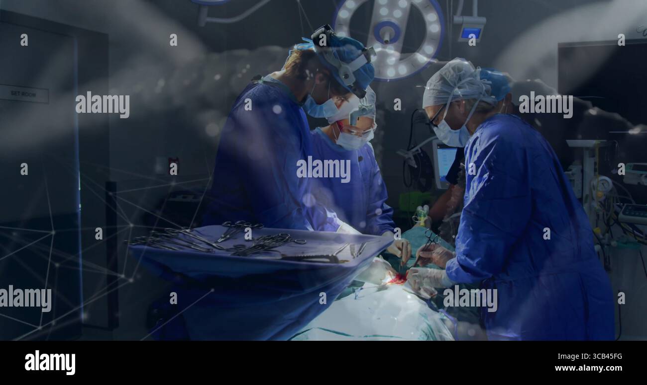 Operating surgical team performing surgery in hospital operating room ...