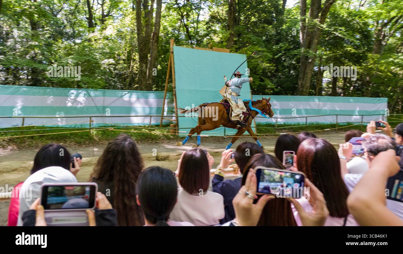 Japanese archer on horseback performs in front of a captivated crowd ...