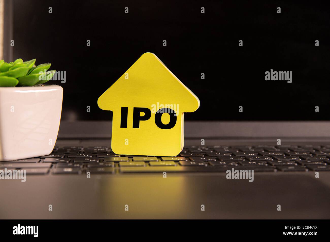 A human hand put a stack of wooden cubes with IPO letters on a wooden ...