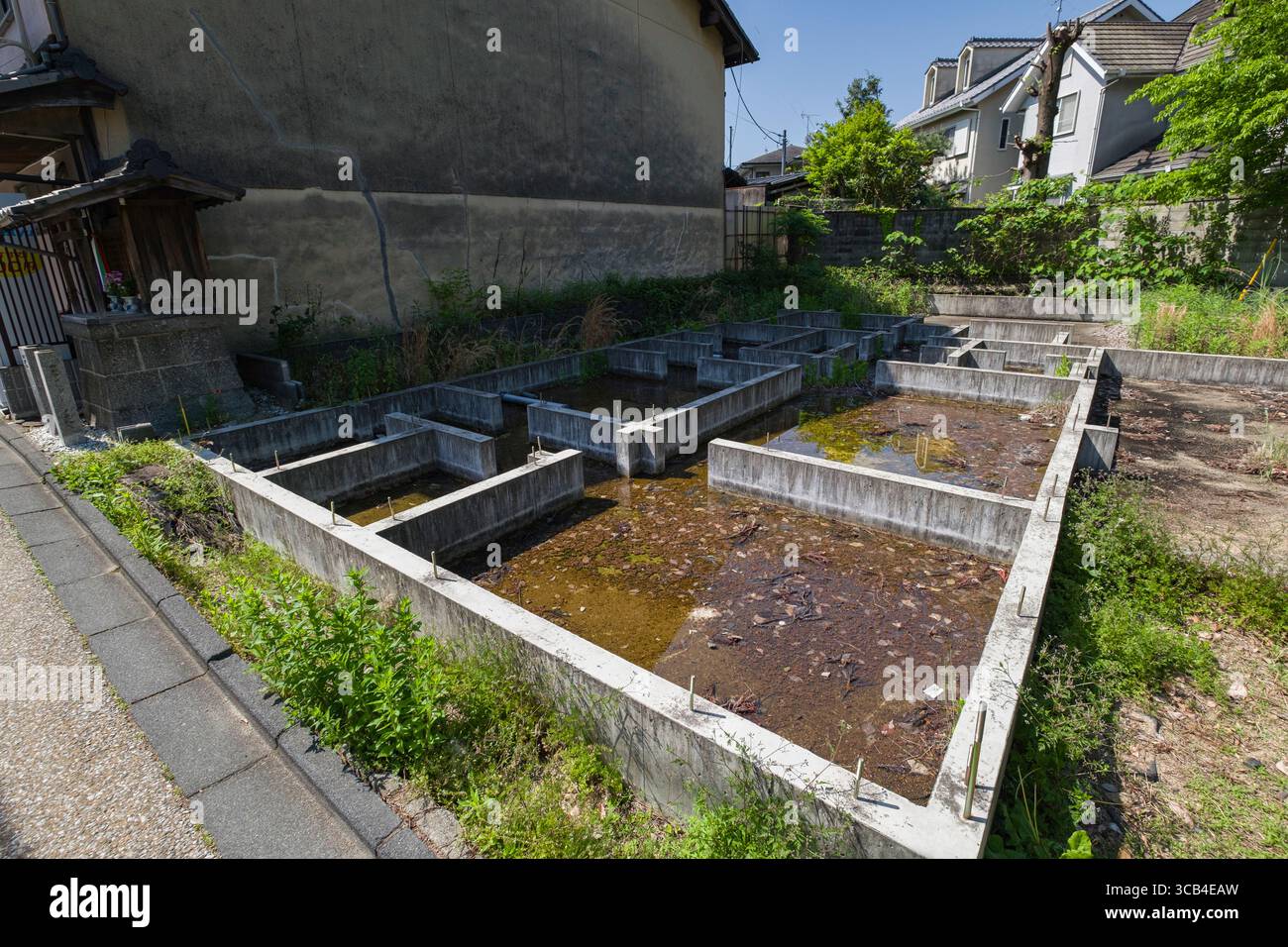 An abandoned lot in an urban neighborhood featuring concrete ...