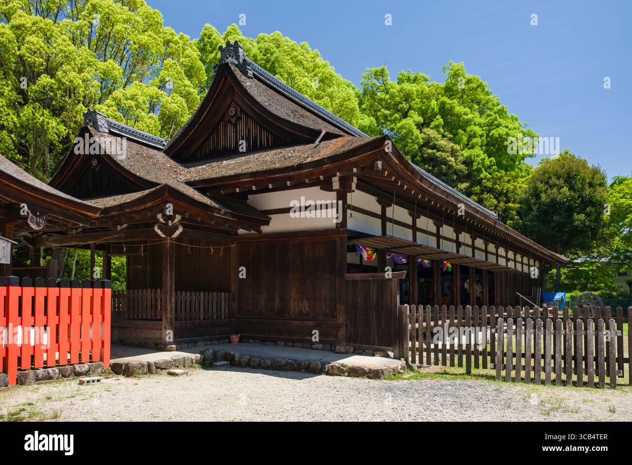 A traditional Japanese temple stands gracefully surrounded by vibrant ...
