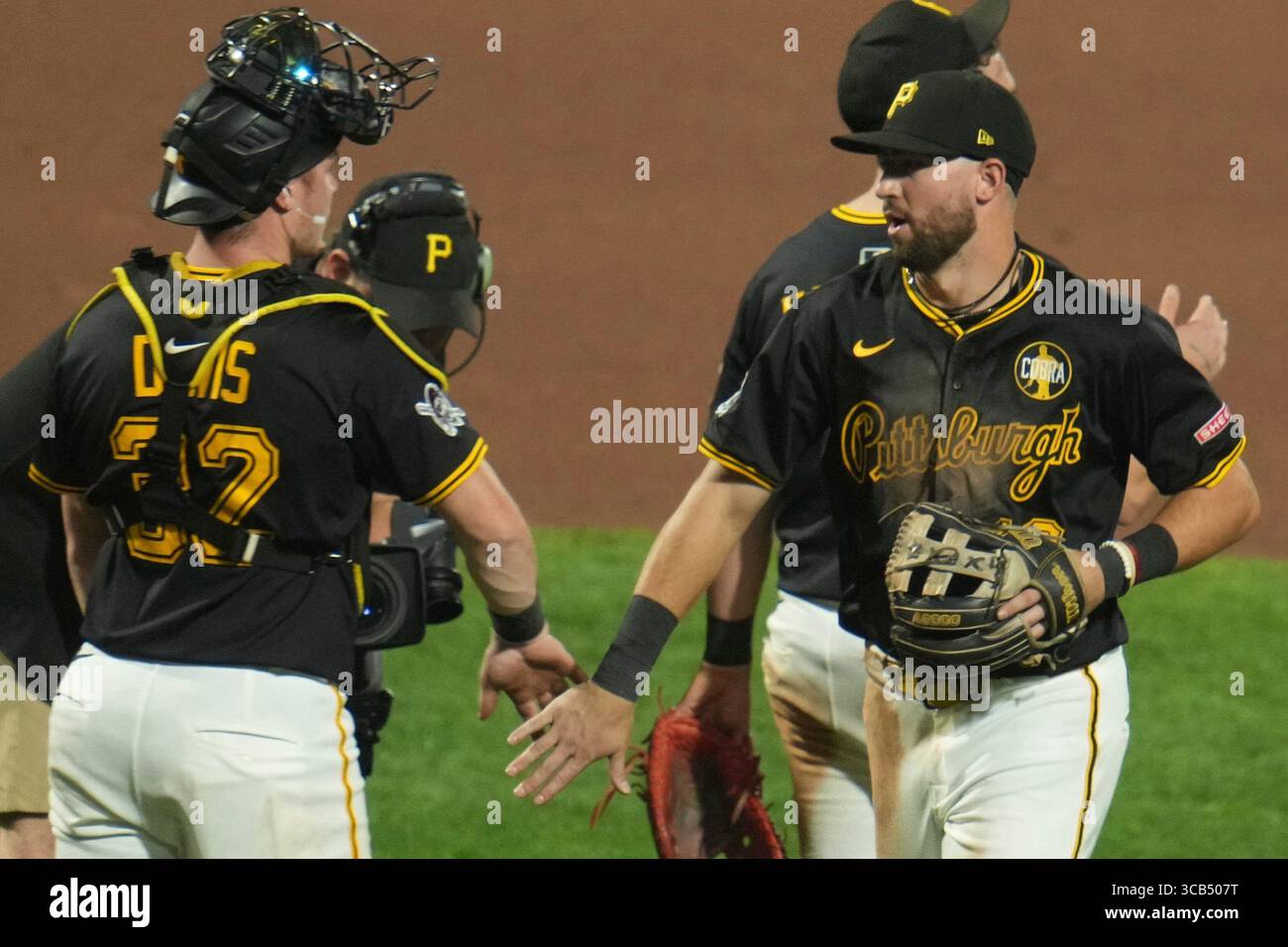 Pittsburgh Pirates' Jared Triolo, right, and catcher Henry Davis, left ...