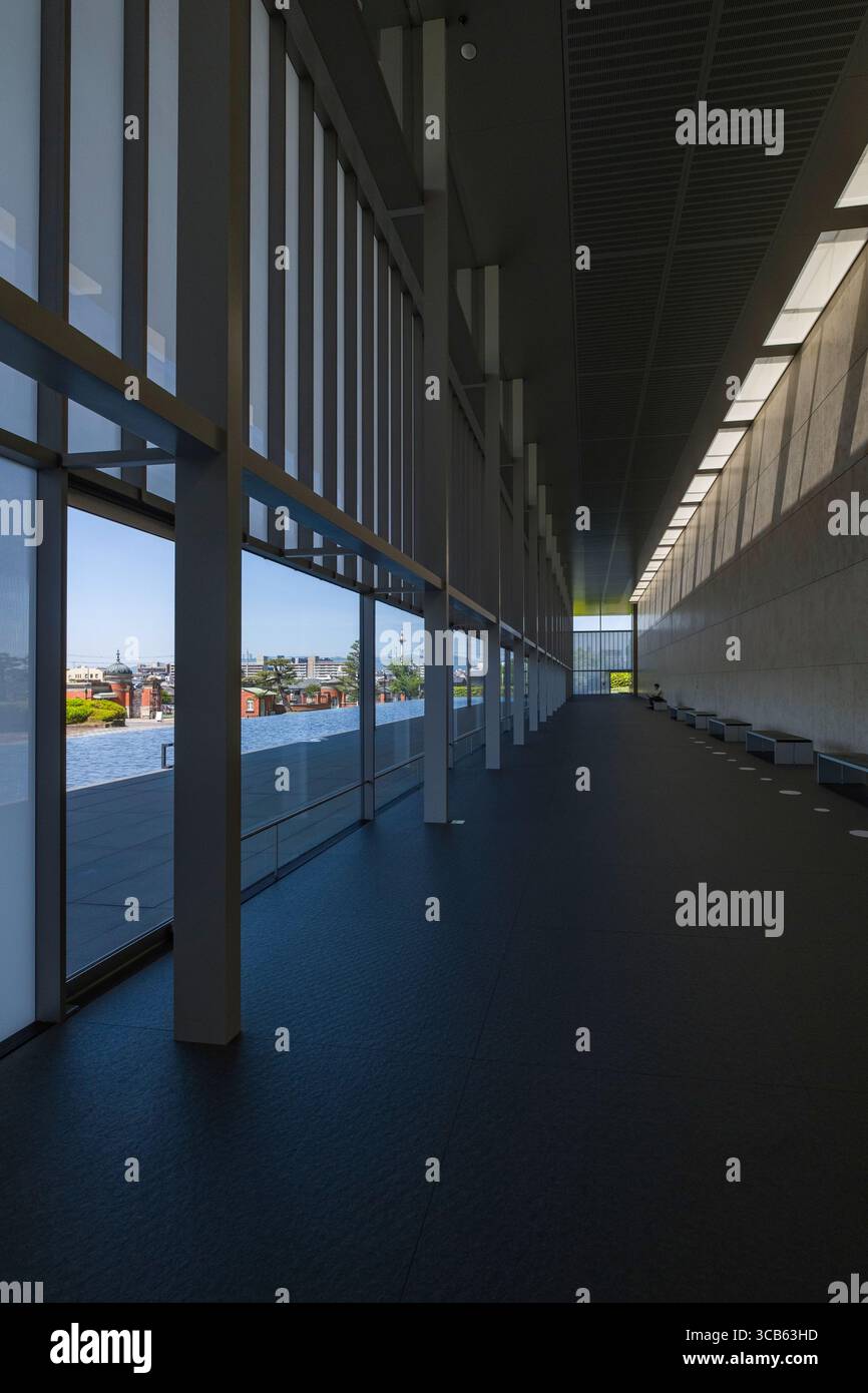 A spacious modern hallway featuring large glass windows and sleek ...