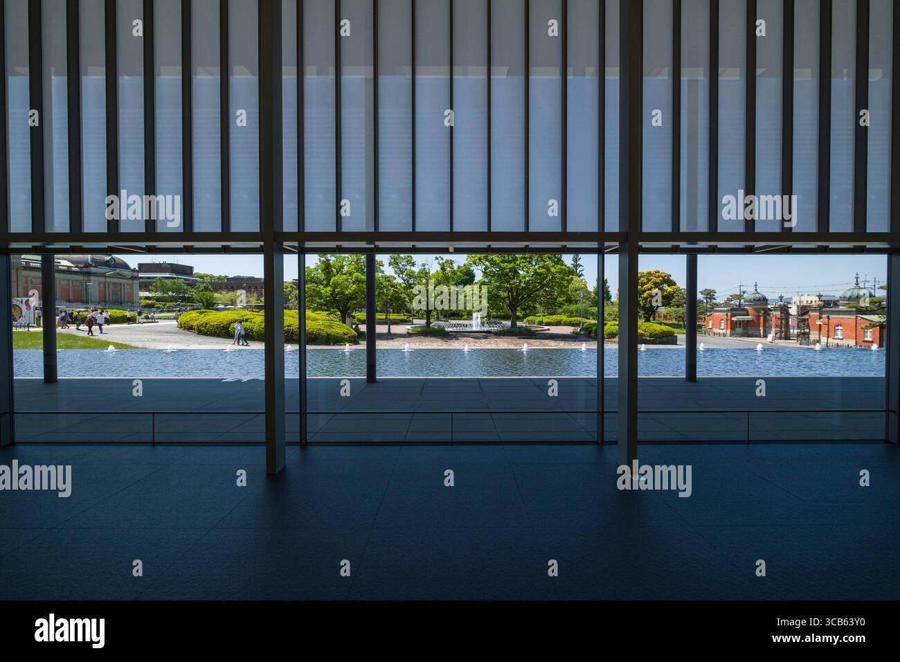 A stunning view of a park with water features seen through a modern ...