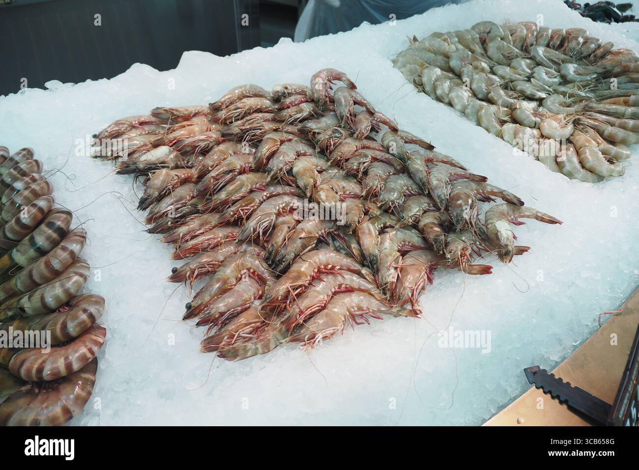 Fresh seafood market display of shrimp and prawns on ice Stock Photo ...