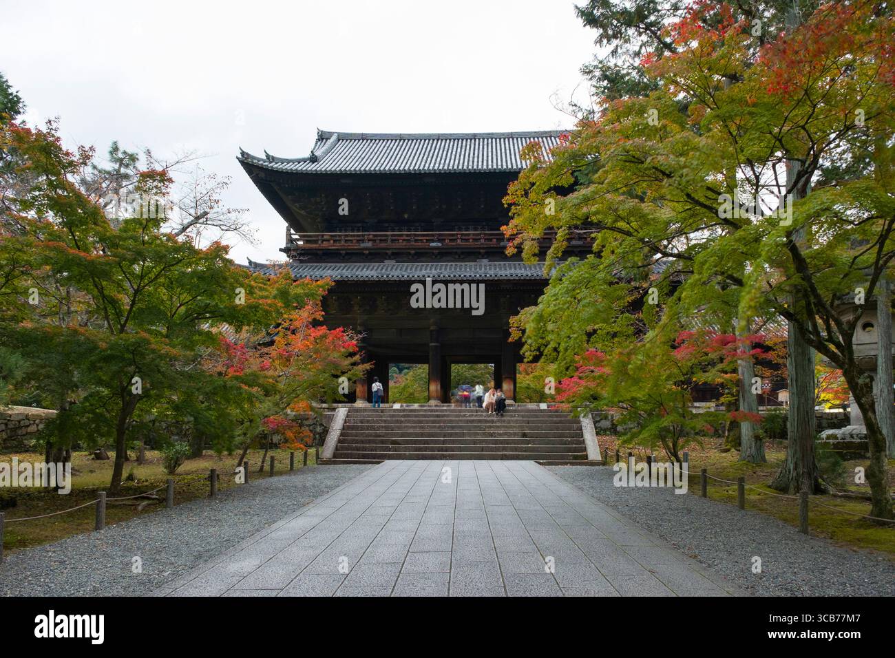 Nanzenji Sammon Gate surrounded by vivid autumn leaves at dusk ...