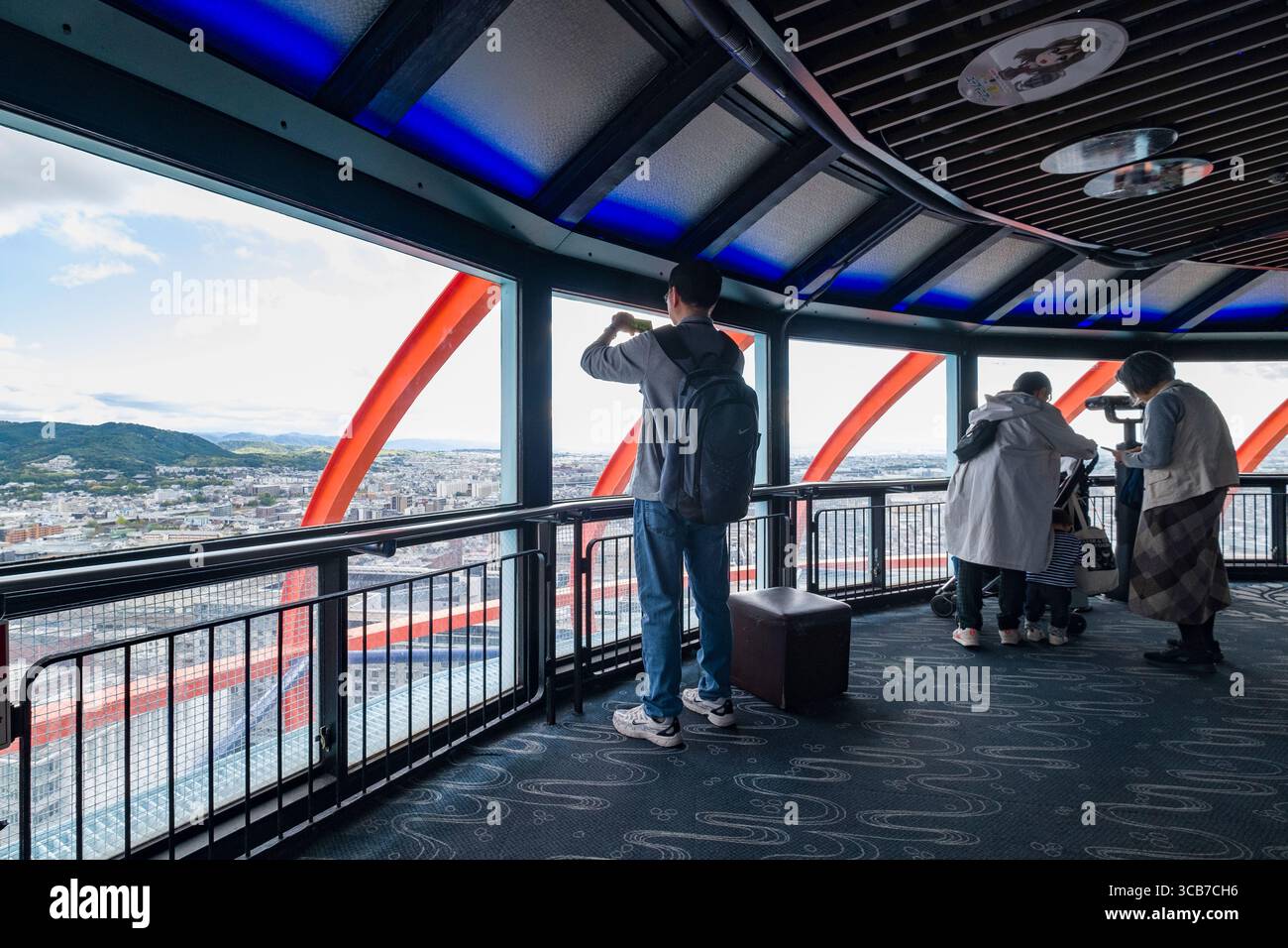 Visitors at Nidec Kyoto Tower observation deck admire stunning city and ...