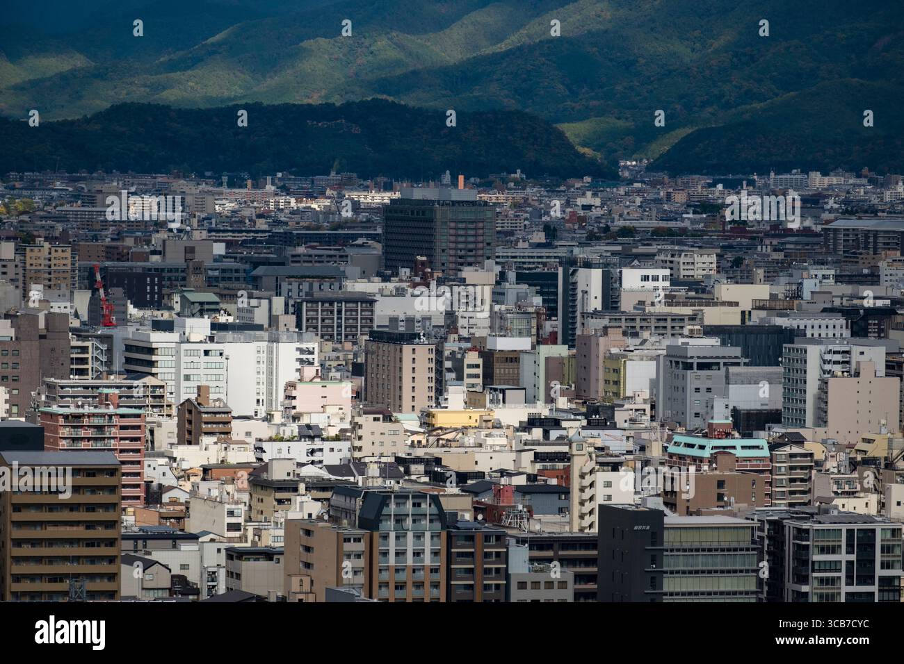 A view of Kyoto, Japan, highlighting dense urban buildings juxtaposed ...