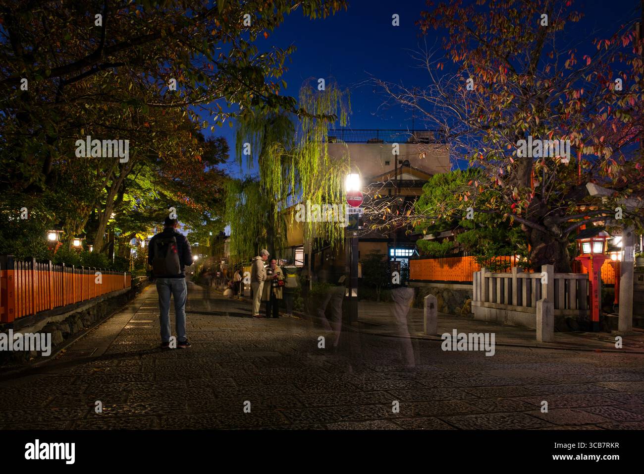 A serene street in Kyoto during night, showcasing autumn foliage ...