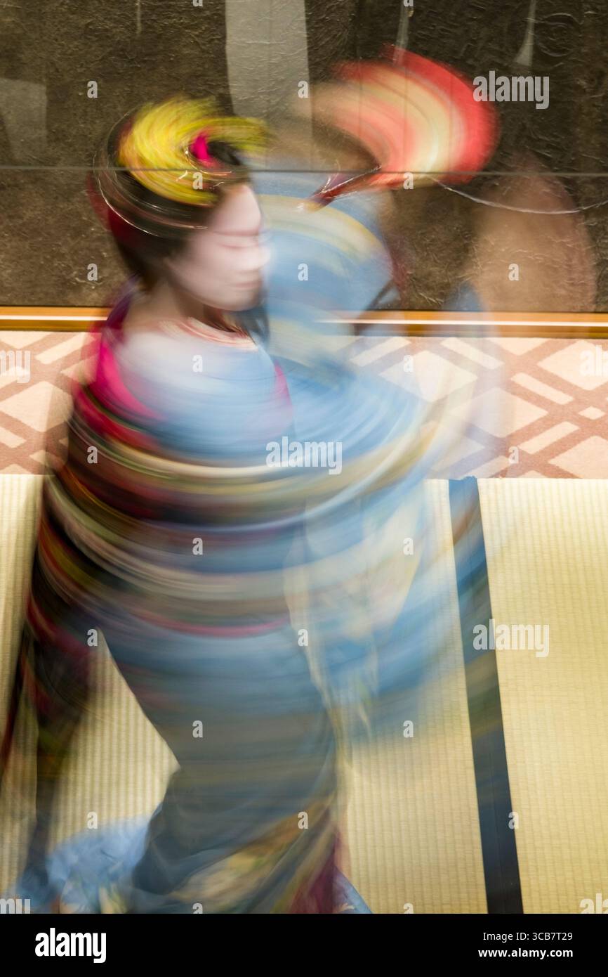 Dynamic motion of a traditional Japanese Maiko dancer, adorned in ...