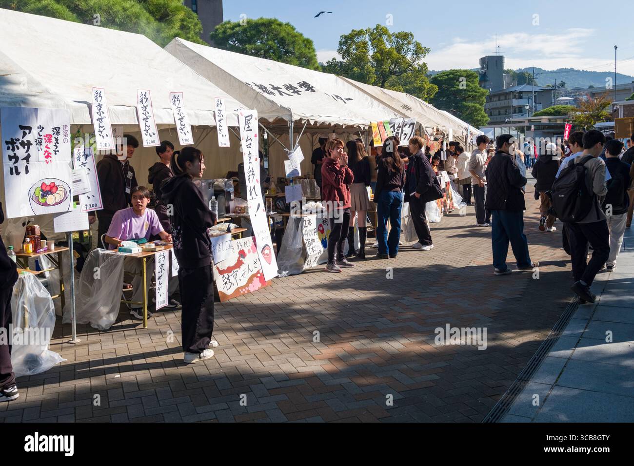 Kyoto University fall festival showcasing food stalls, people walking ...