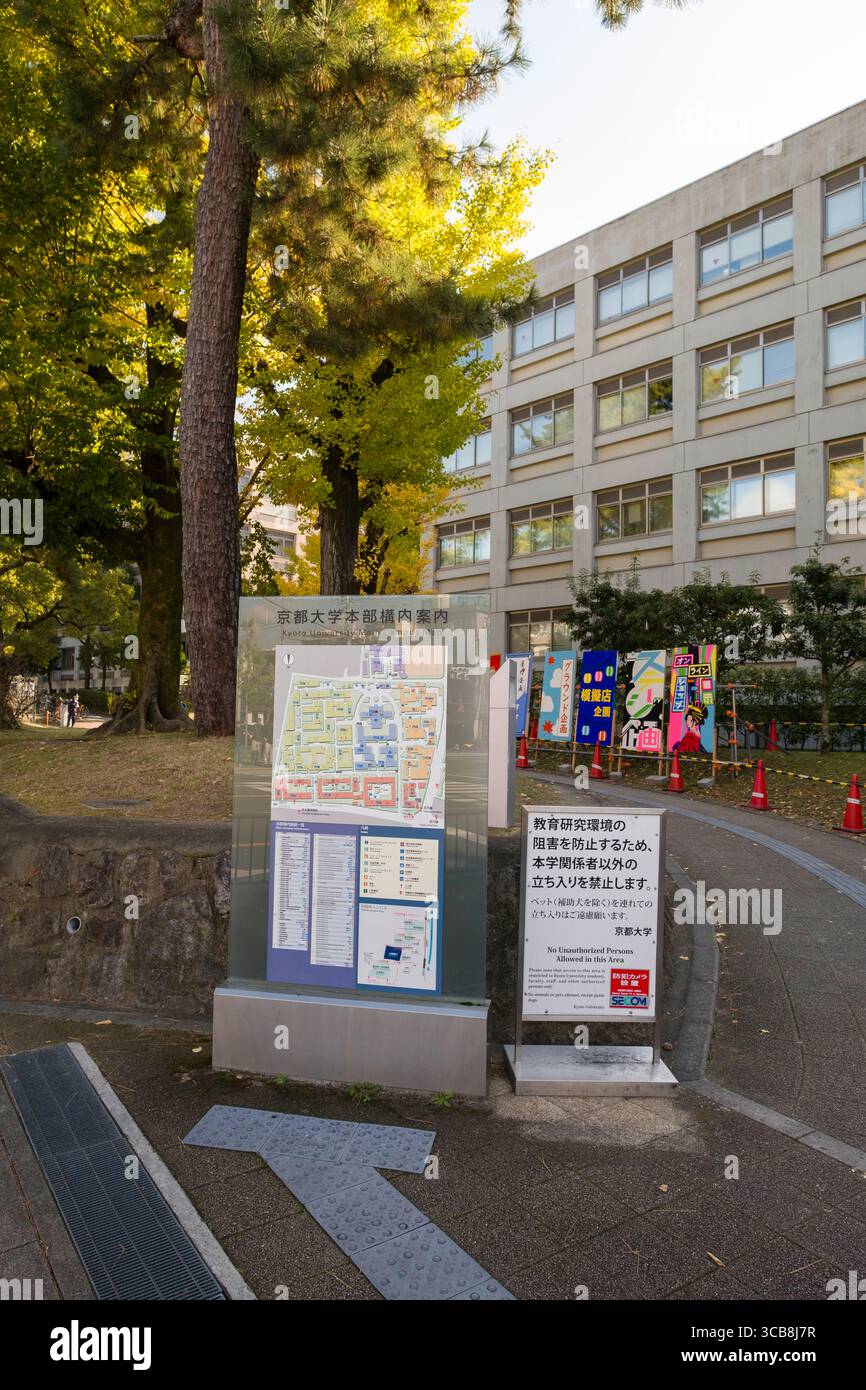 A directory sign standing on a university campus with surrounding ...