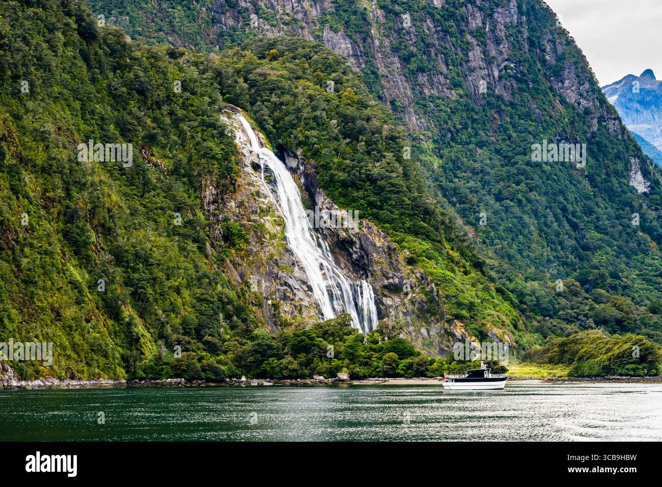 Boat in front of Lady Bowen Falls at Milford Sound, Fiordland National ...