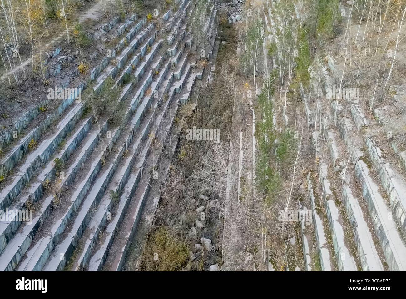 An old marble quarry overgrown with trees Stock Photo - Alamy