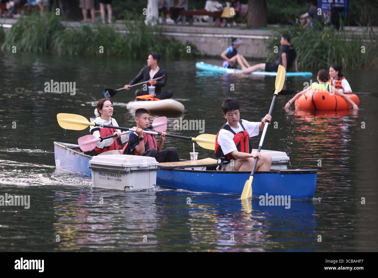 People experience paddleboarding and canoeing on Liangma River in ...