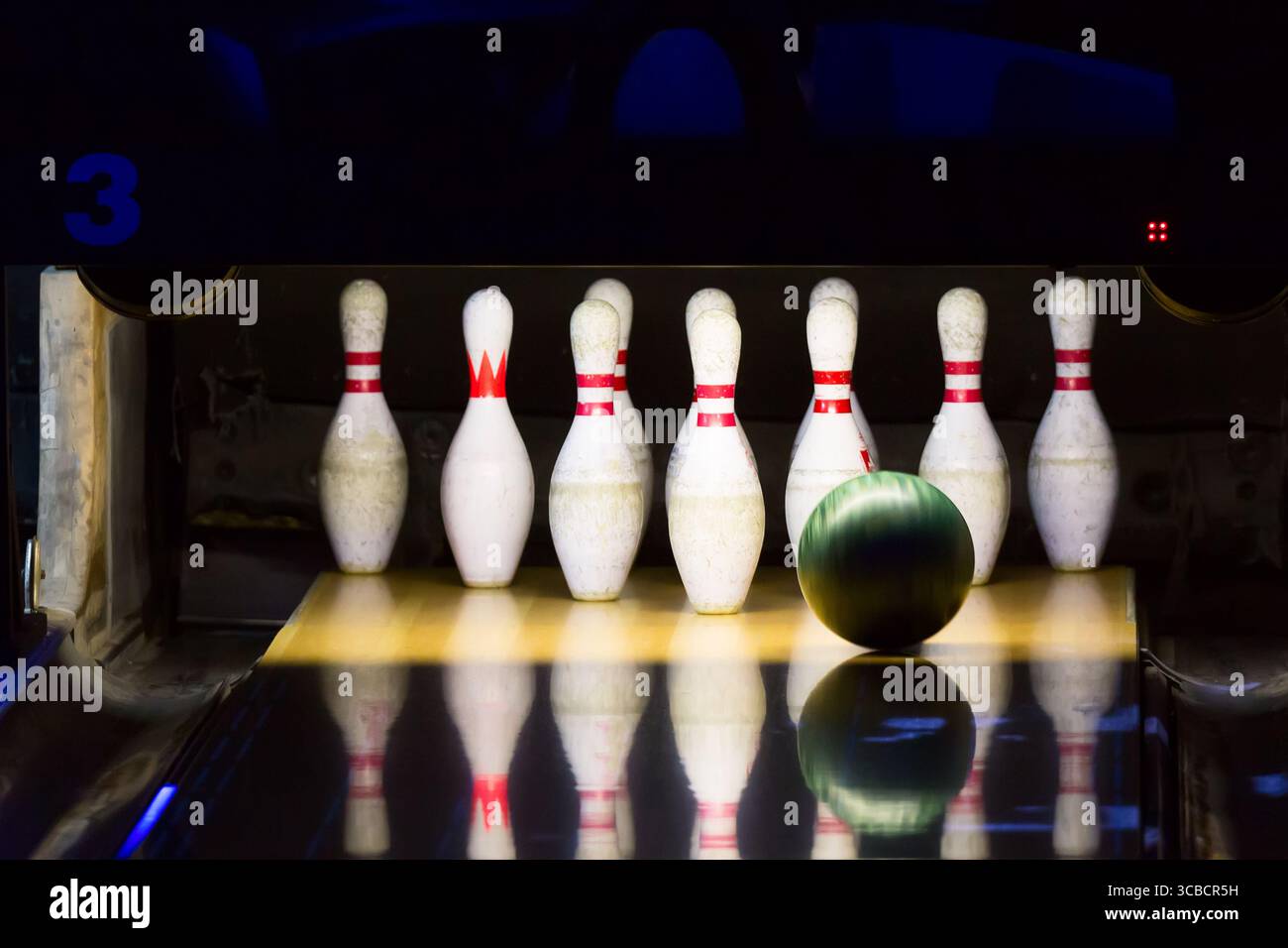 Bowling alley. Green bowling ball rolling into the pins Stock Photo - Alamy