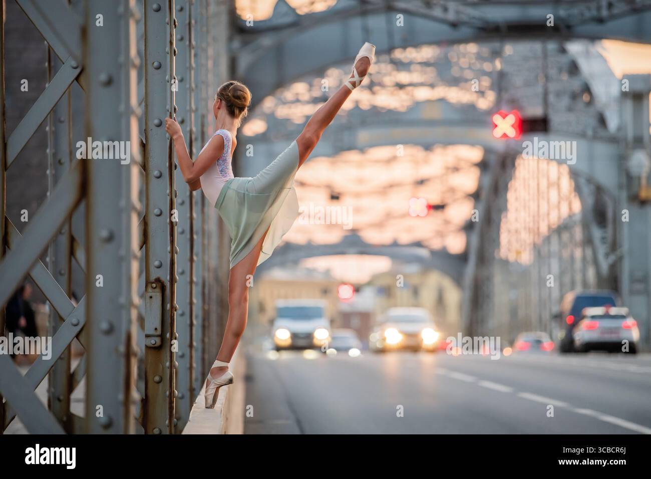 ballerina performing elegant ballet pose on a bridge at sunset Stock ...