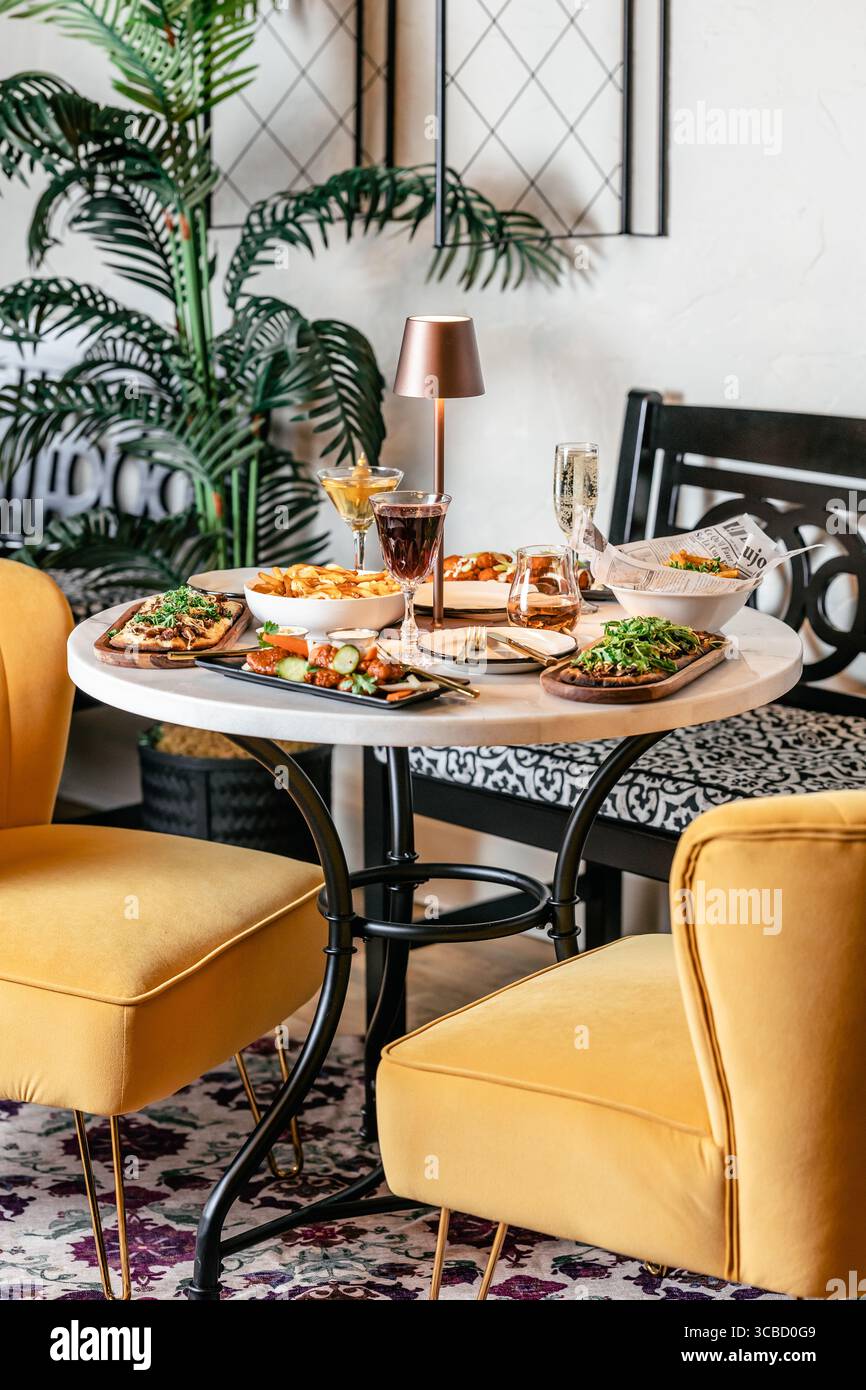 Elegant restaurant table set with drinks, appetizers, and décor Stock ...